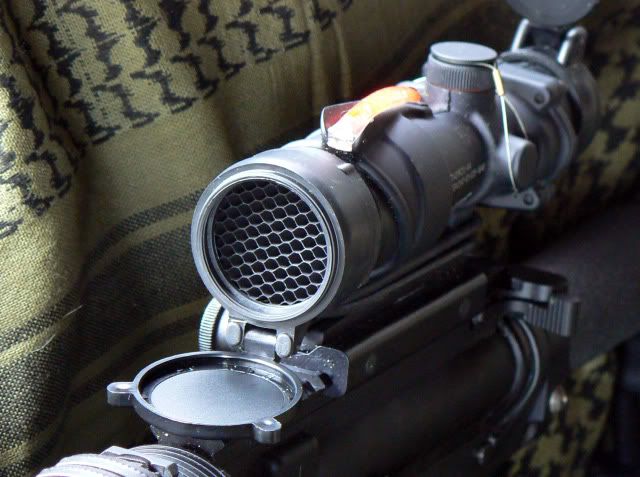 Are there any flip-up lens covers for ACOGs? > Optics, Mounts, and ...